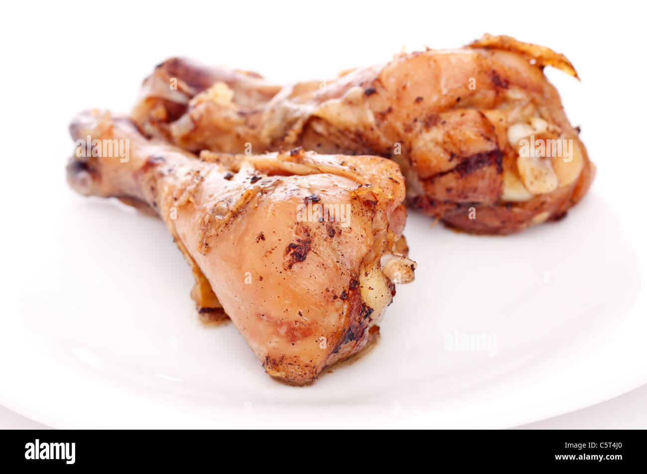 two crispy fried chicken legs on a white dish Stock Photo - Alamy