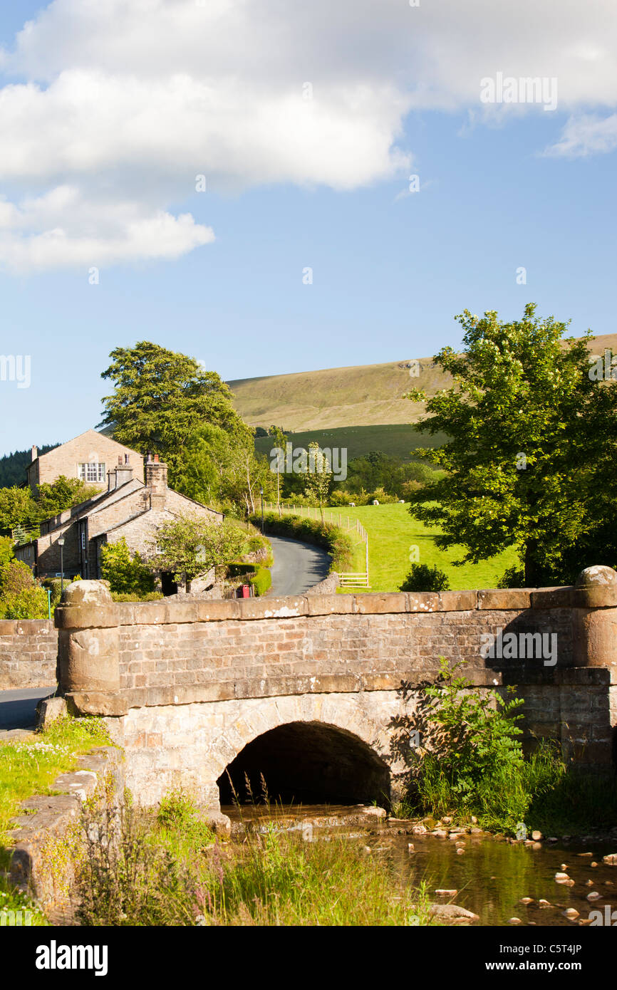 The pretty, Feudal village of Downham, nestling beneath Pendle Hill in ...