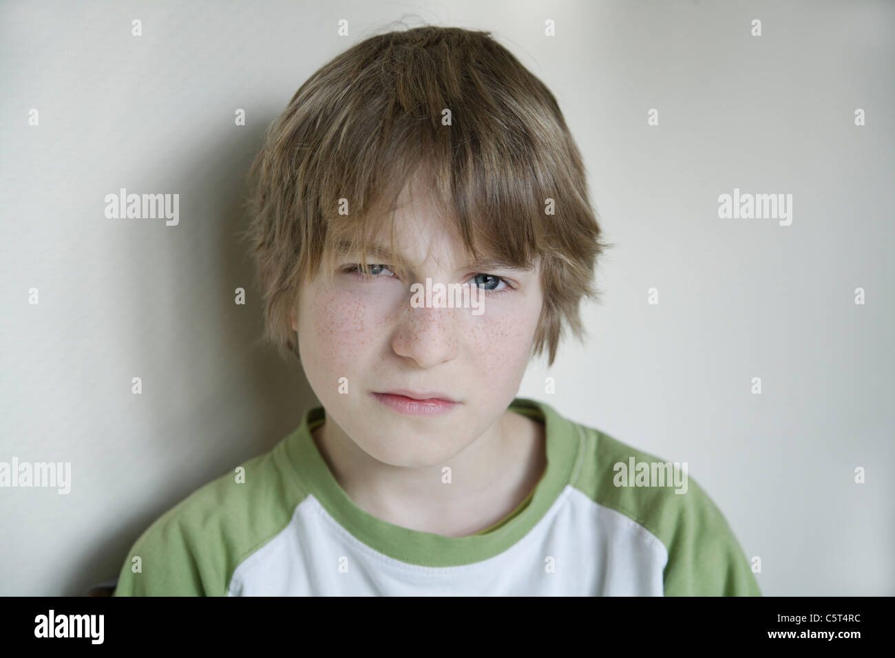 Close up of angry teenage boy against white background Stock Photo - Alamy