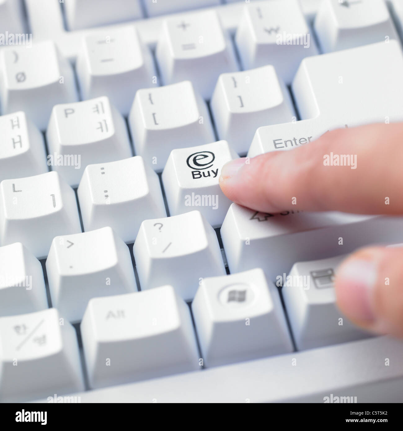 A person pushing a key in a keyboard Stock Photo - Alamy