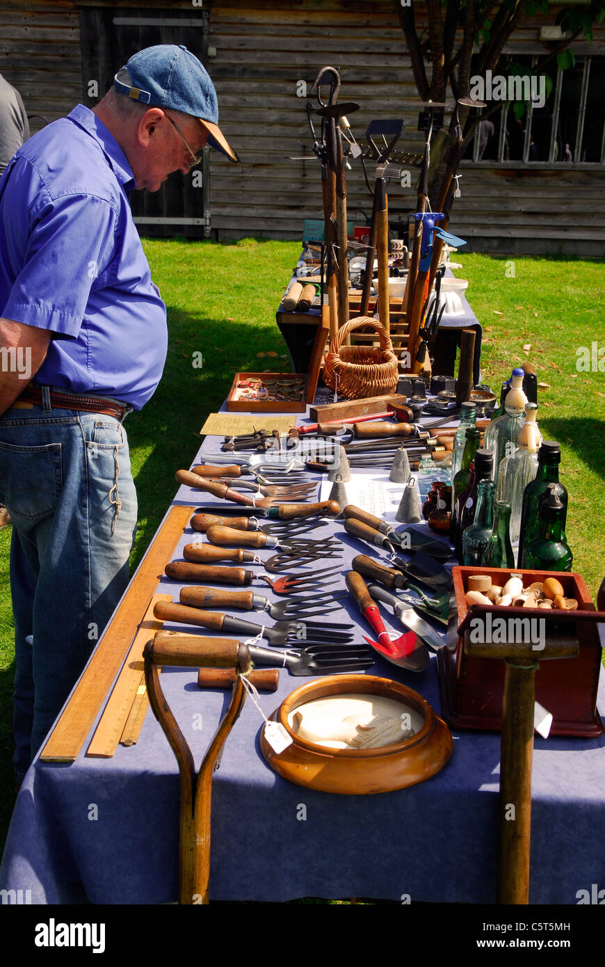 Visitor perusing agricultural and other implements at Rustic Sunday, an ...