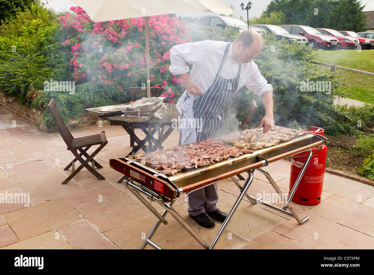 chef cooking Catering barbecue various meats Stock Photo - Alamy