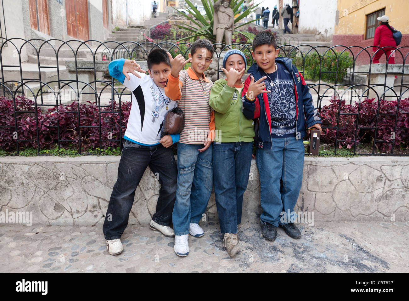 Four young Peruvian boys pose for the camera on the stairs leading to ...