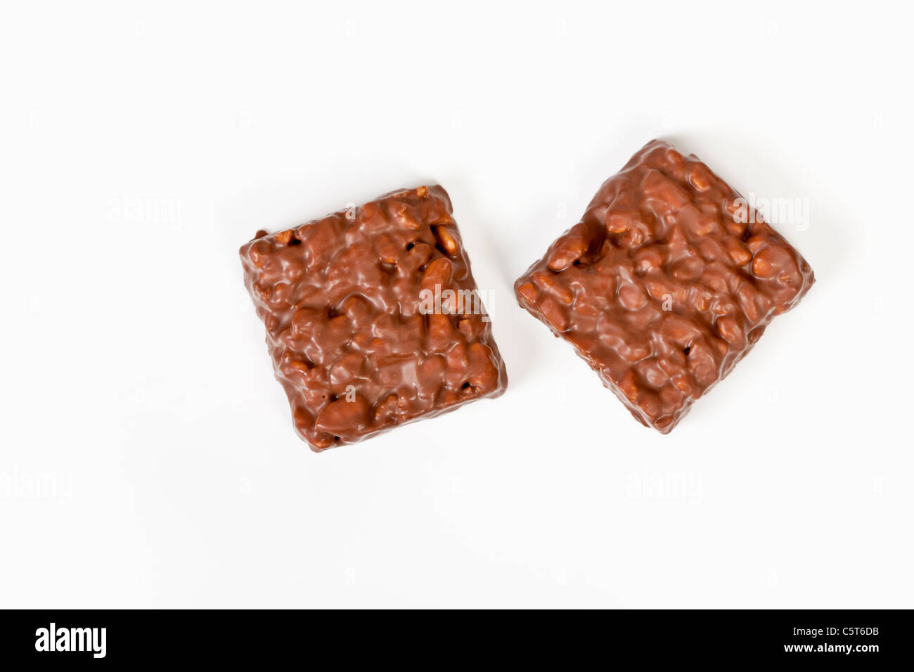 chocolate coated puffed rice on white background Stock Photo - Alamy