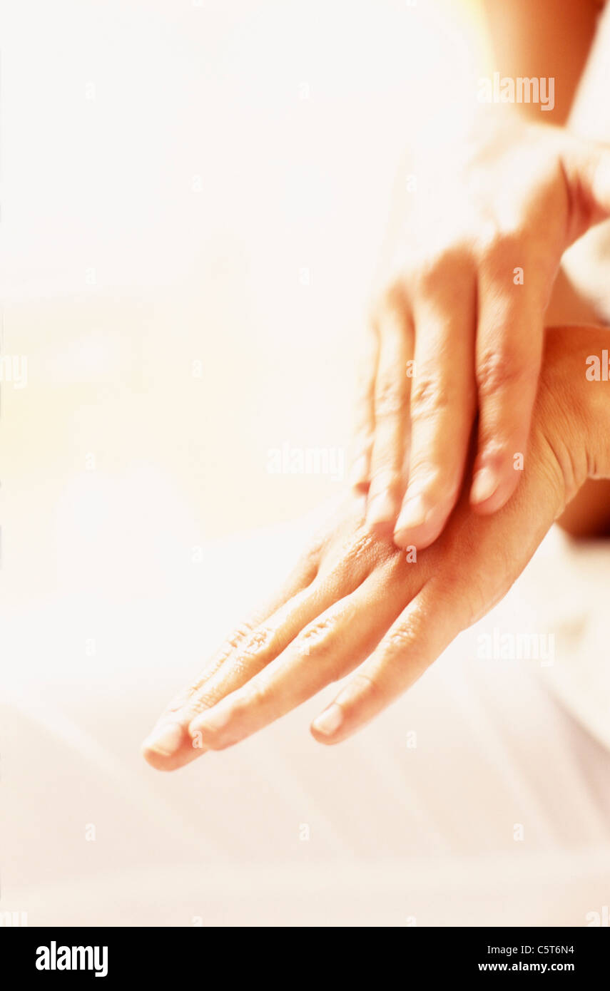 Woman applying moisturizer to hand Stock Photo - Alamy