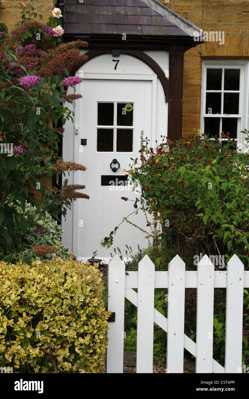 White gate and door of a country cottage in the village of Sywell, UK ...