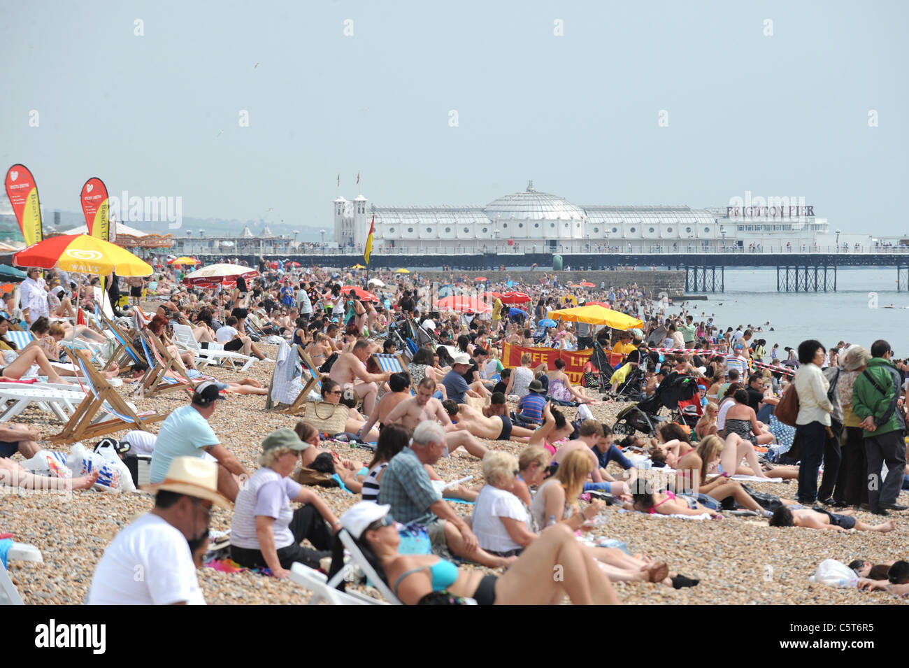 A packed Brighton beach today with the seafront behind as crowds ...