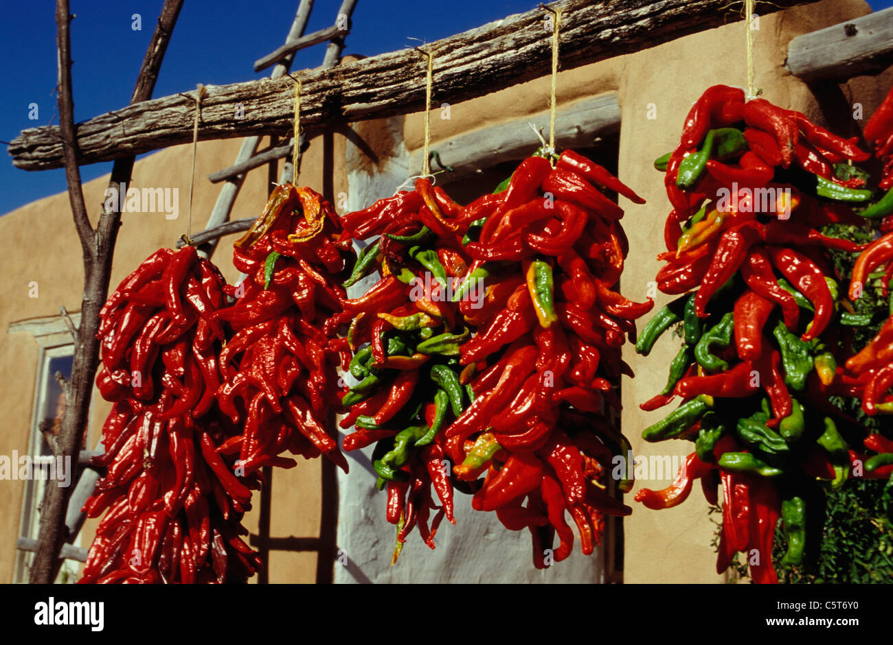 Chilies hanging outside house Stock Photo - Alamy