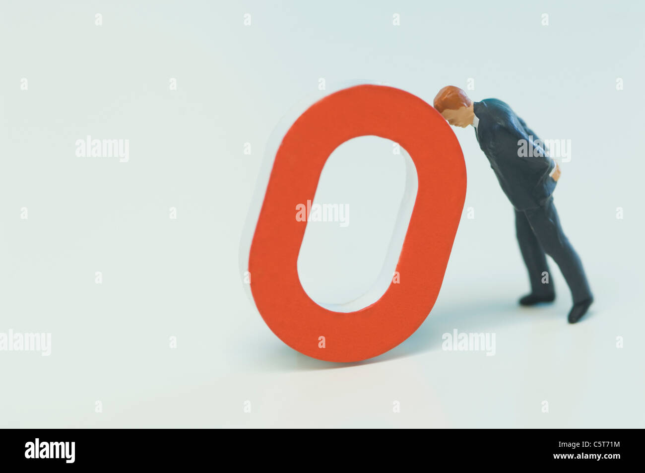 Business figurine pushing zero round on white background Stock Photo ...