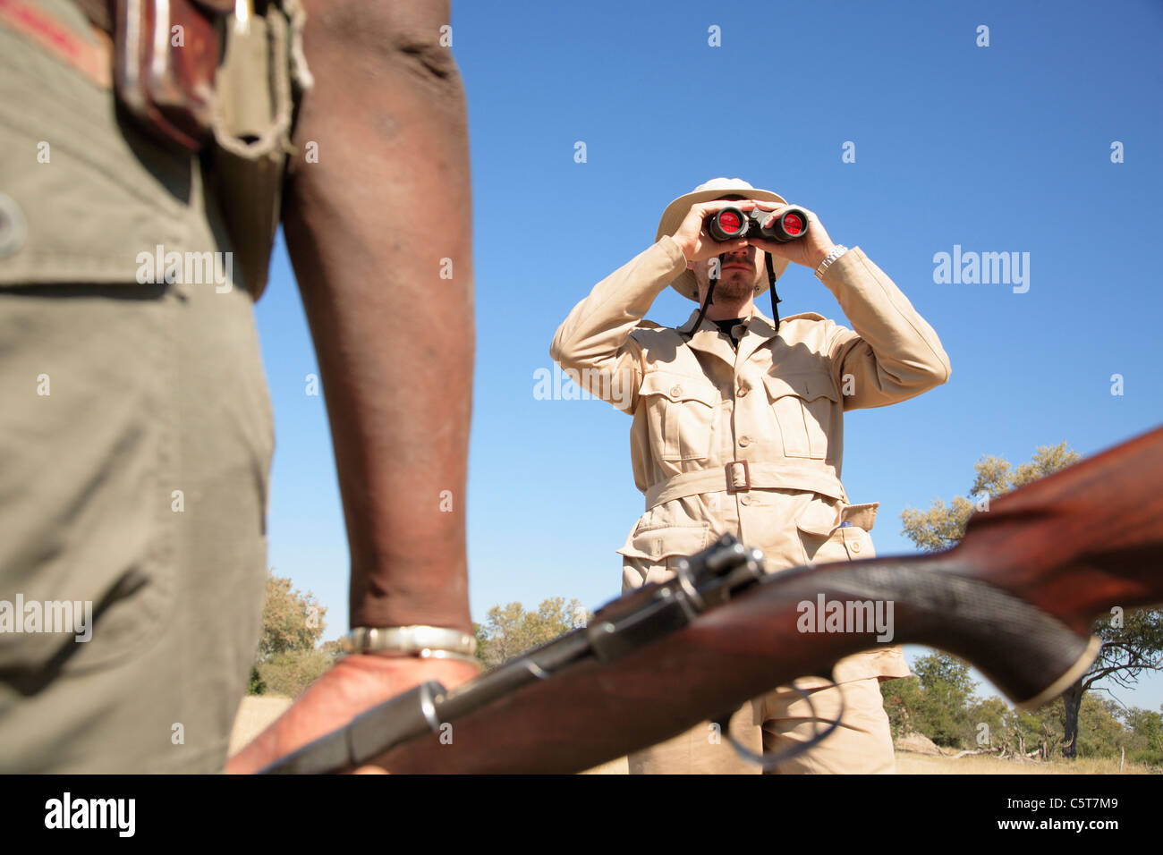 Africa, Botswana, Okavango Delta, Men on Safari Stock Photo - Alamy
