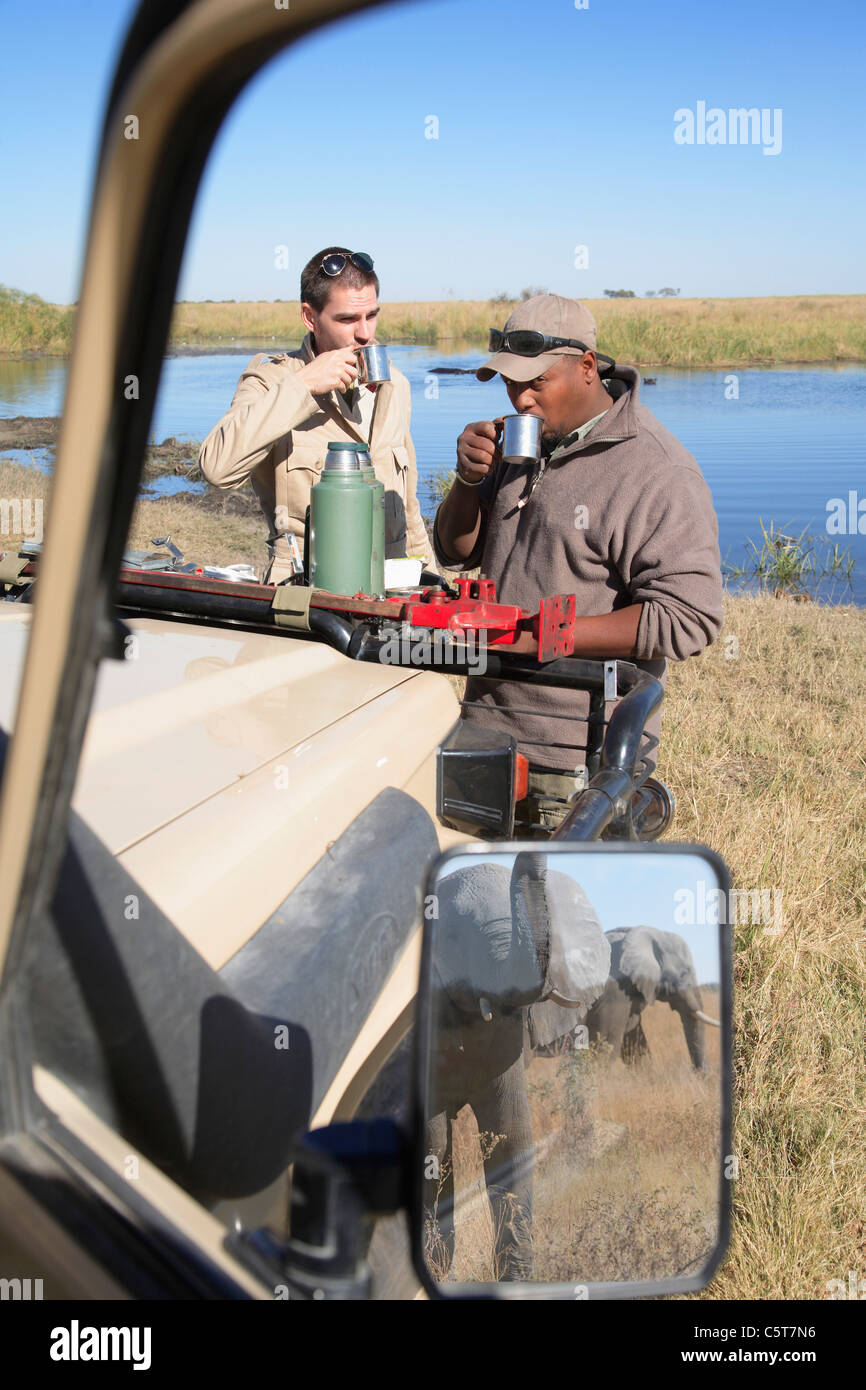 Africa, Botswana, Okavango Delta, Men on safari having a break Stock ...