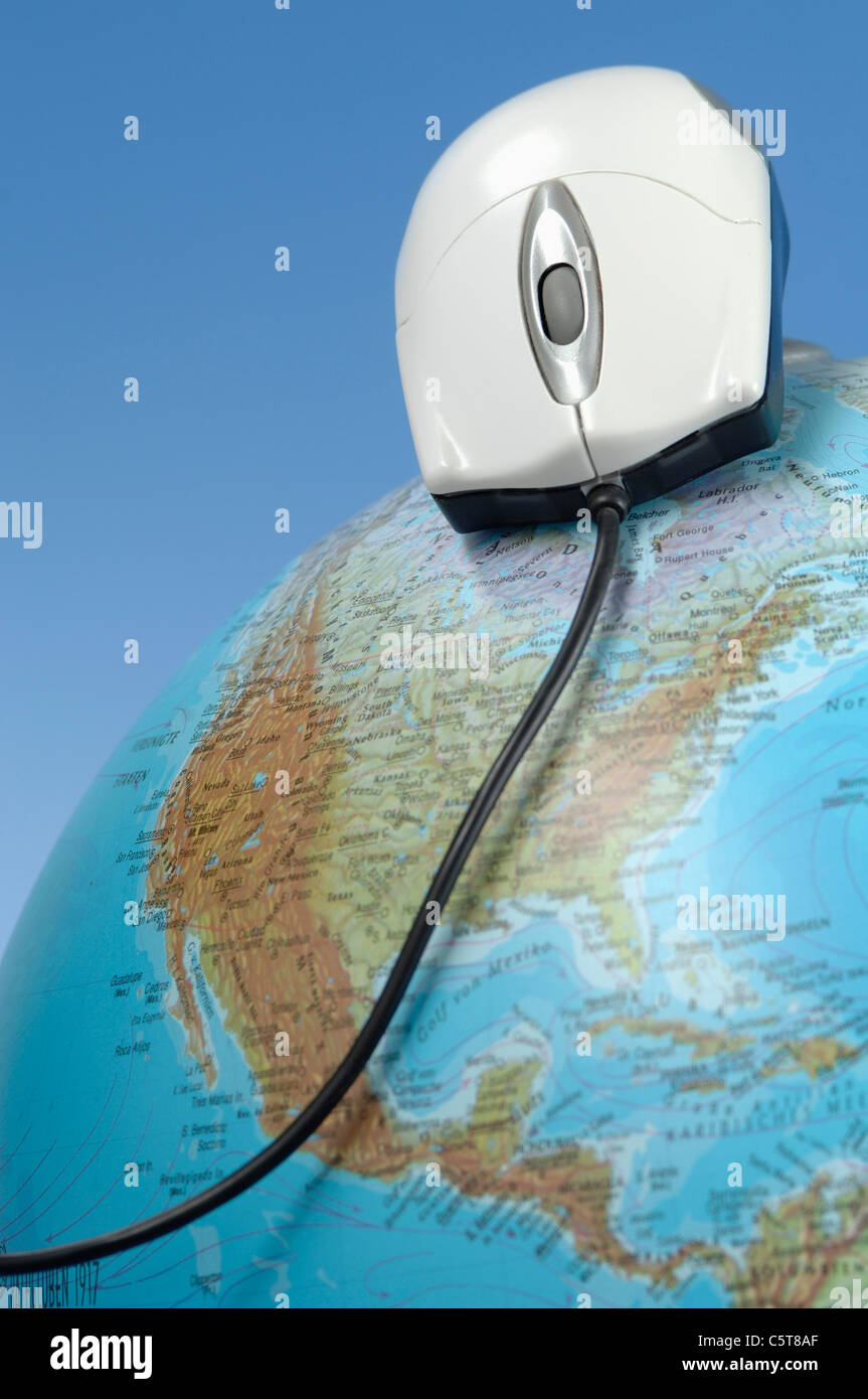 Computer mouse on world globe Stock Photo - Alamy