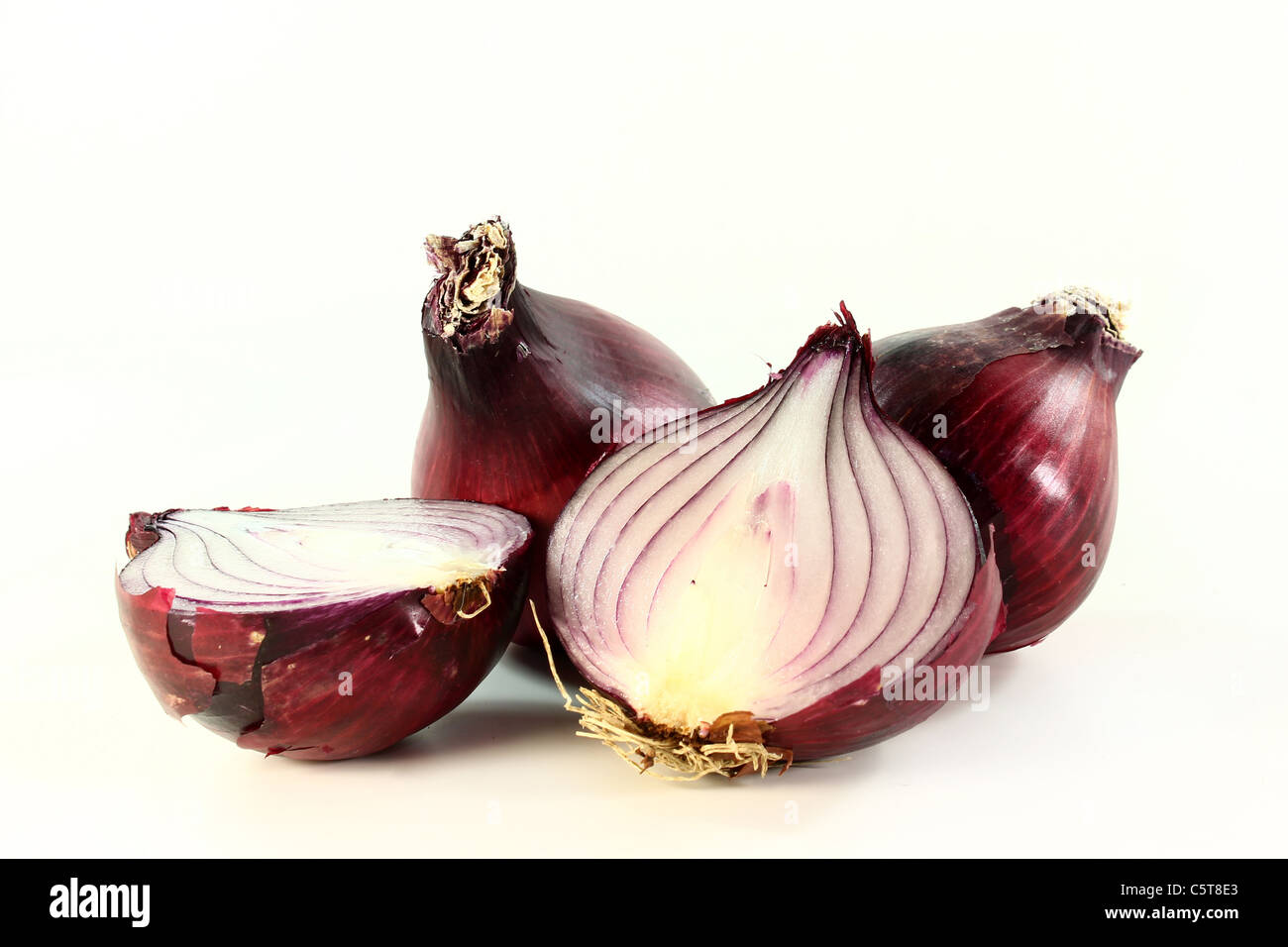 three red onions on a white background Stock Photo - Alamy