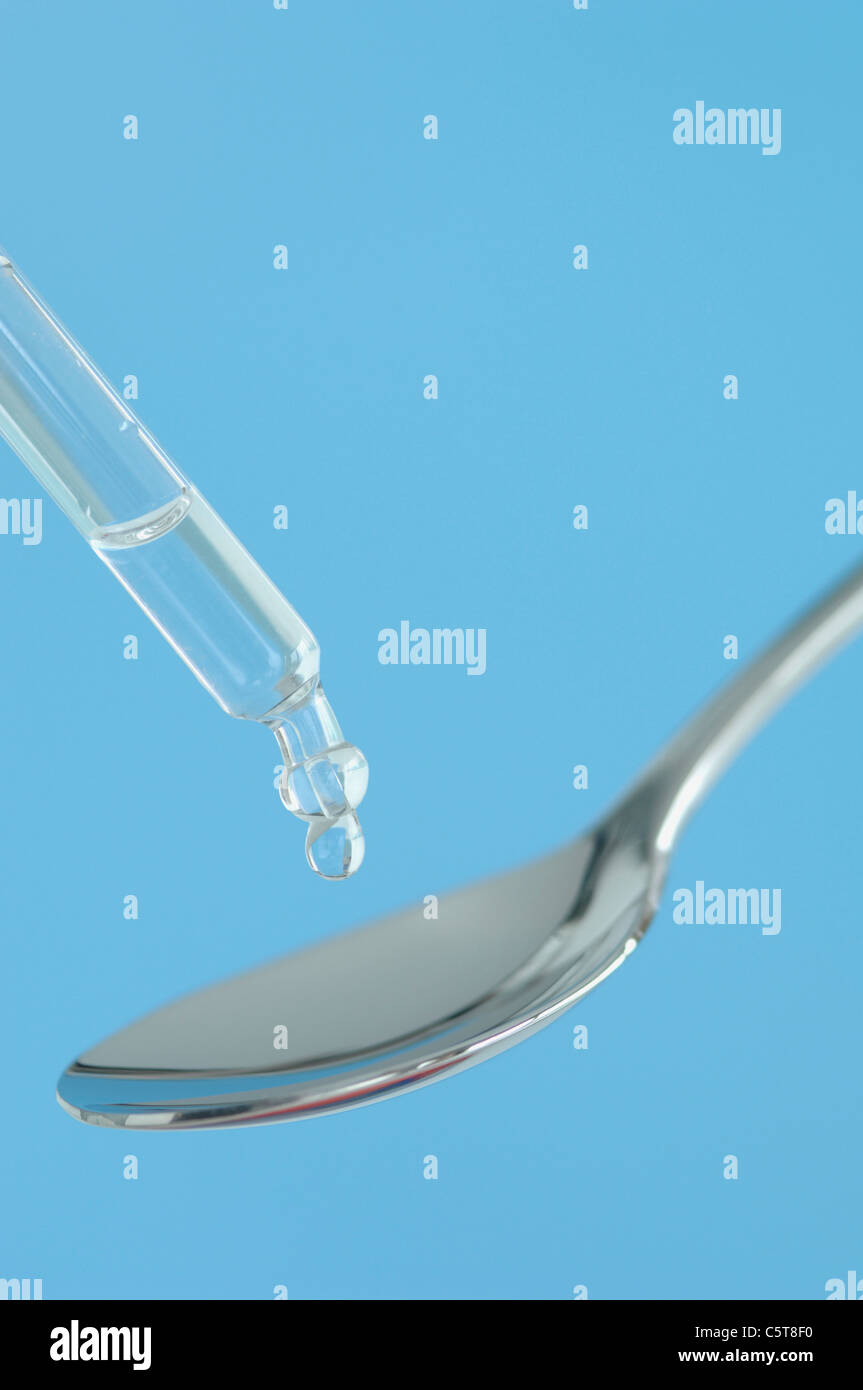 Drop falling from a pipette onto spoon, close-up Stock Photo - Alamy