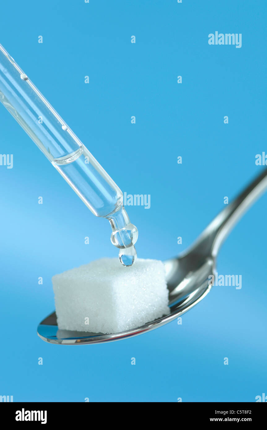 Drop falling from a pipette onto sugar cube Stock Photo - Alamy