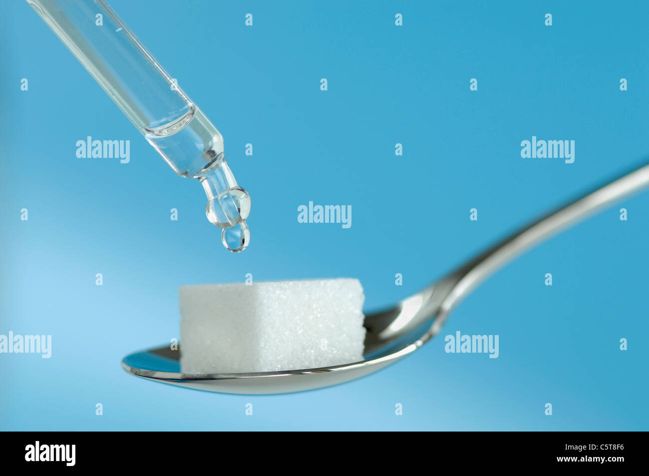 Drop falling from a pipette onto sugar cube Stock Photo - Alamy