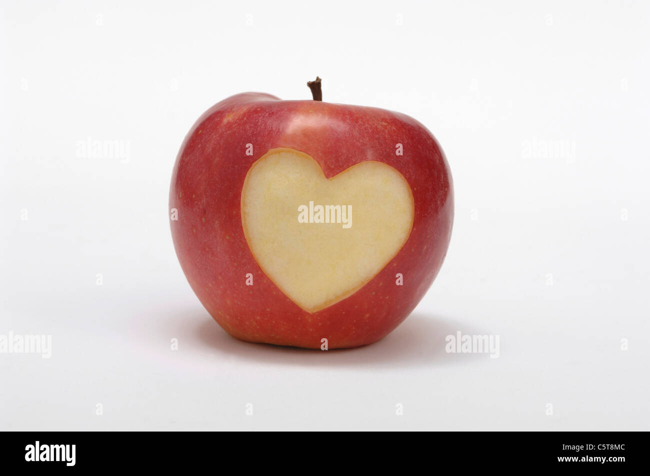 Apple with carved heart, close up Stock Photo - Alamy