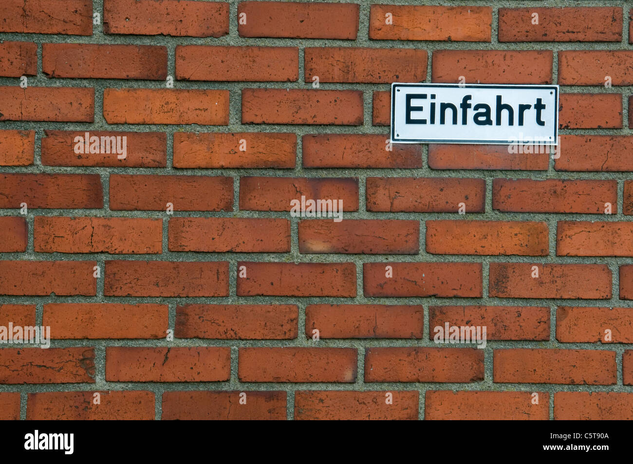 Entrance sign on brick wall, close-up Stock Photo - Alamy