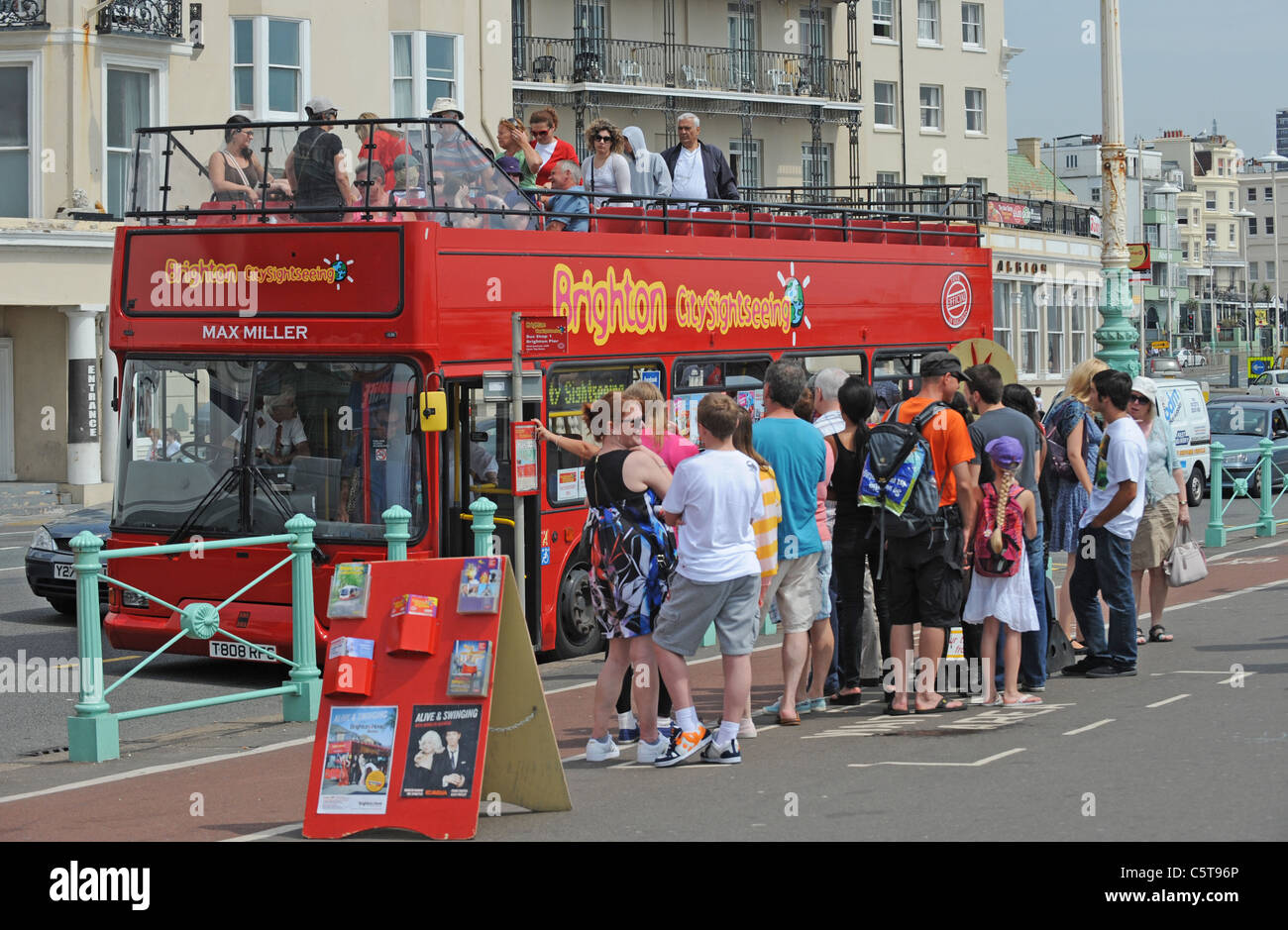Tourists enjoy the hot weather and a trip out on an open top Brighton ...