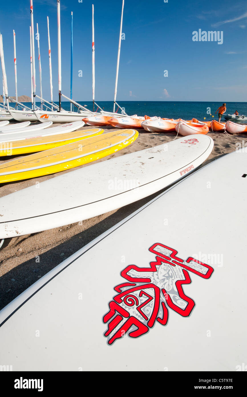 Sailing boats, kayaks, and stand up boards on the beach at an activity ...