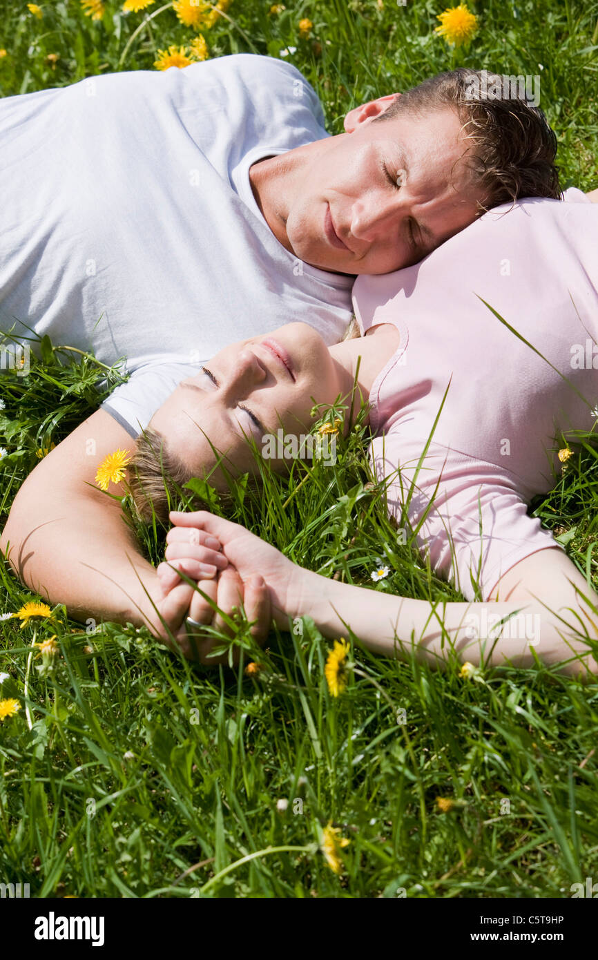 Germany, Bavaria, Munich, Young couple lying in meadow, elevated view Stock Photo - Alamy