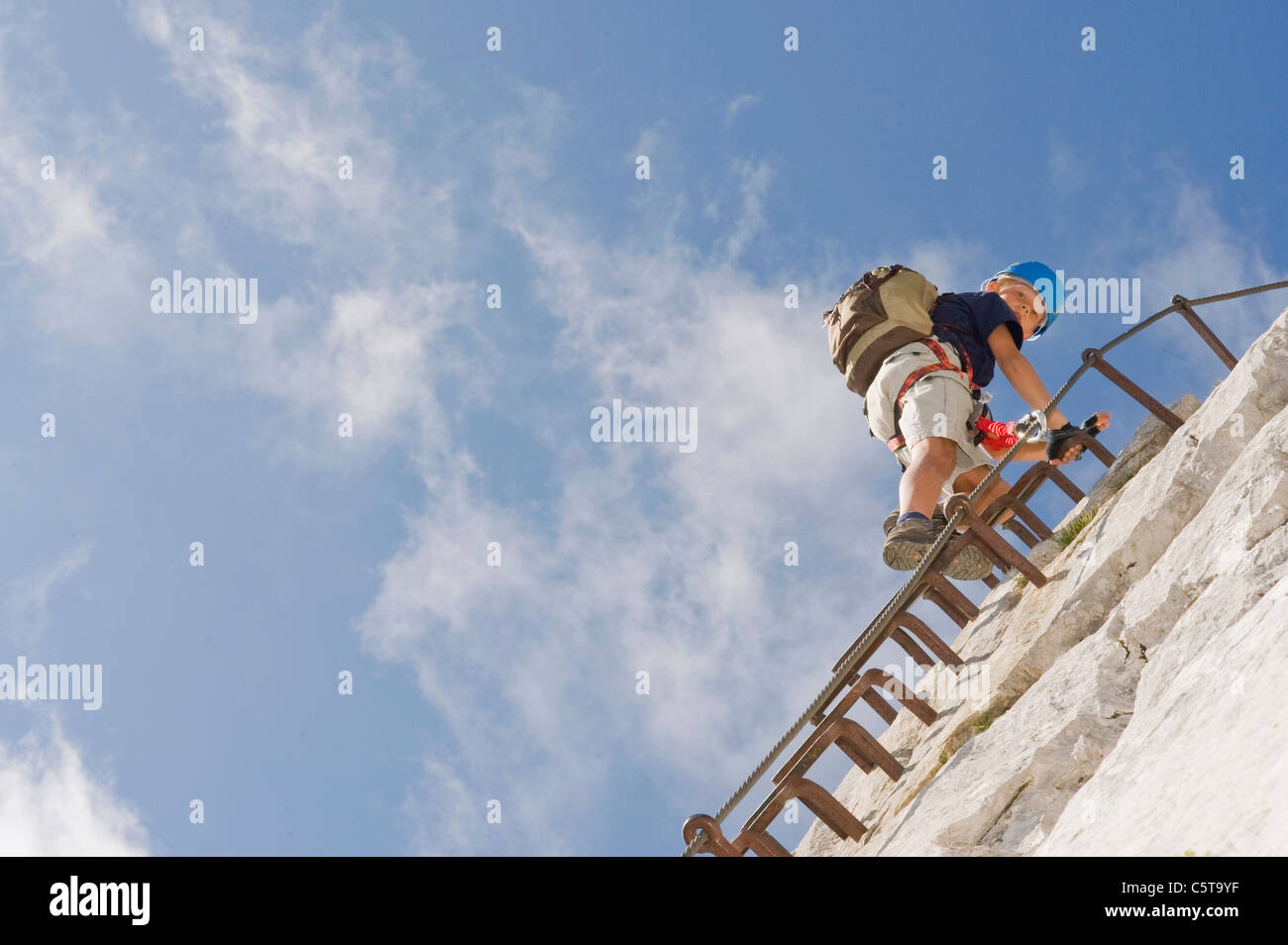Germany, Garmisch-Partenkirchen, Alpspitz, Boy (10-11) climbing rock ...