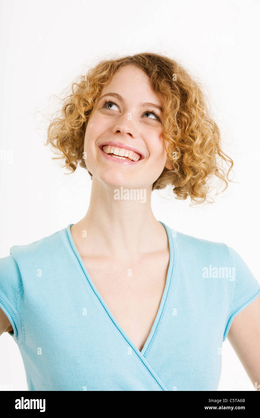 Young woman looking up, smiling, portrait Stock Photo - Alamy
