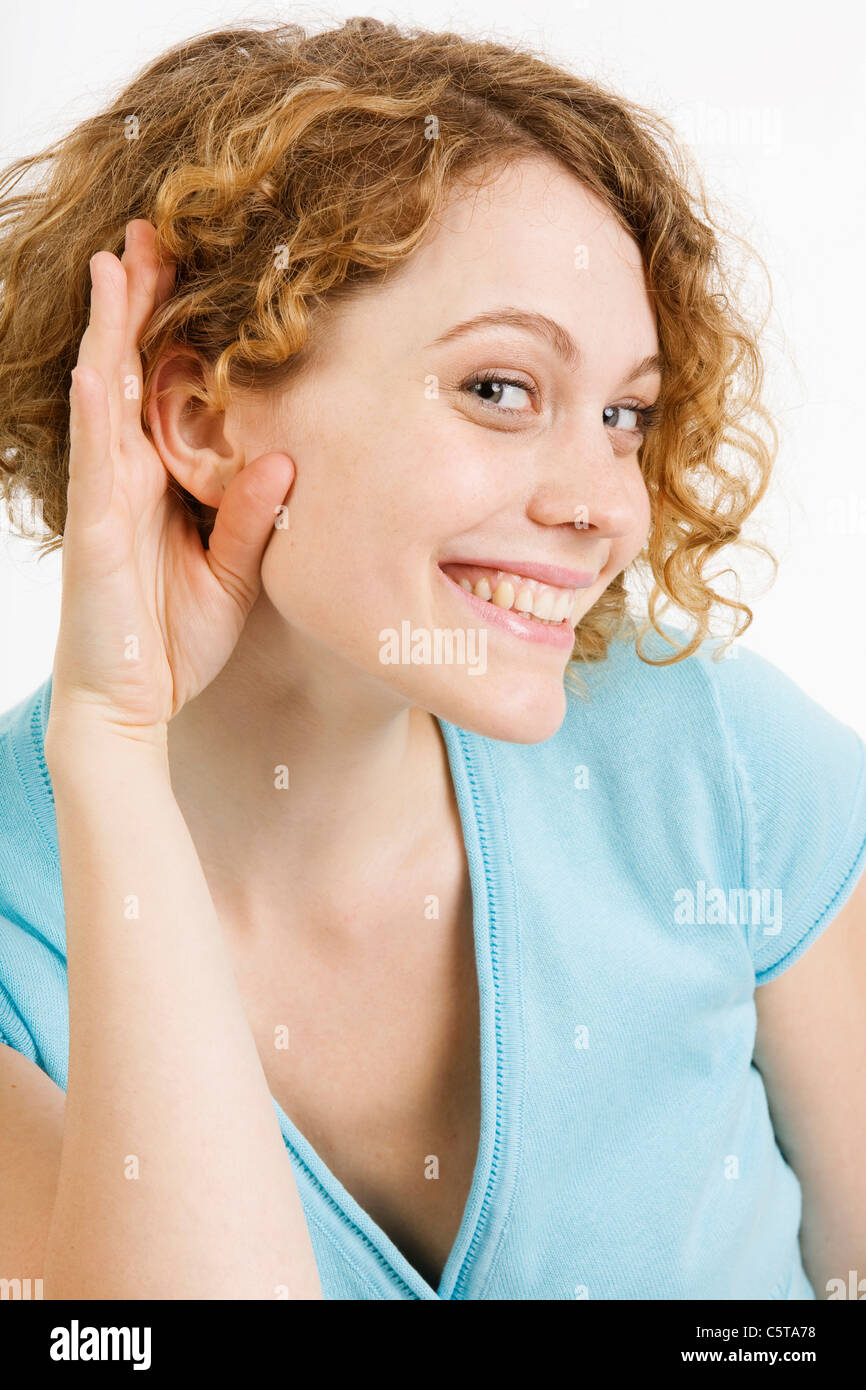Young Woman Putting Hand To Ear High Resolution Stock Photography and ...