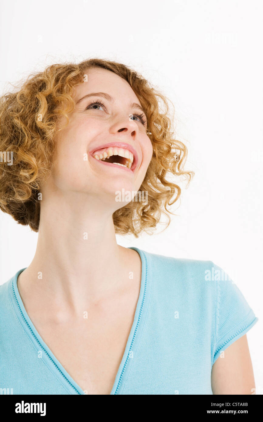 Young woman laughing, looking up, portrait Stock Photo - Alamy