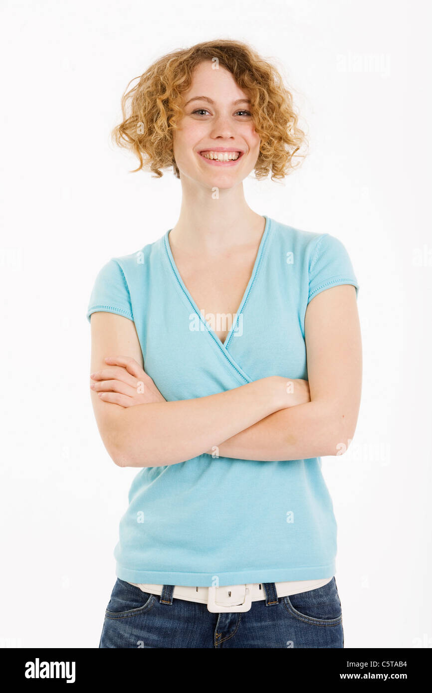 Young woman, arms crossed, smiling, portrait Stock Photo - Alamy