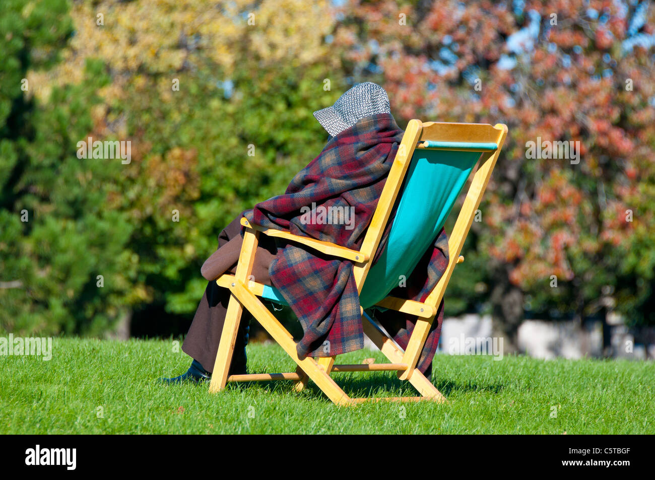 Elderly person resting in a park Stock Photo - Alamy