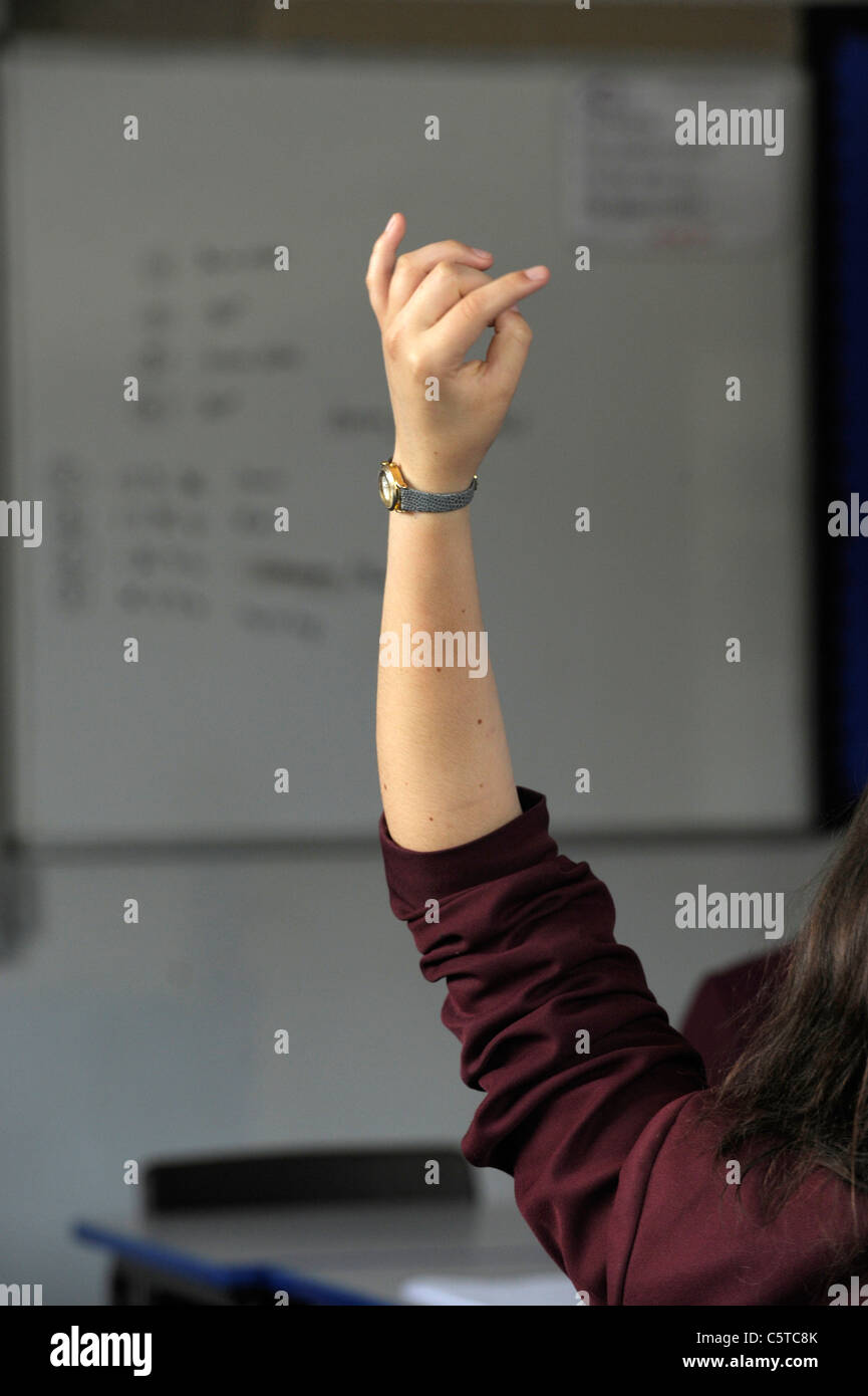 Child's hand raised in school classroom Stock Photo - Alamy