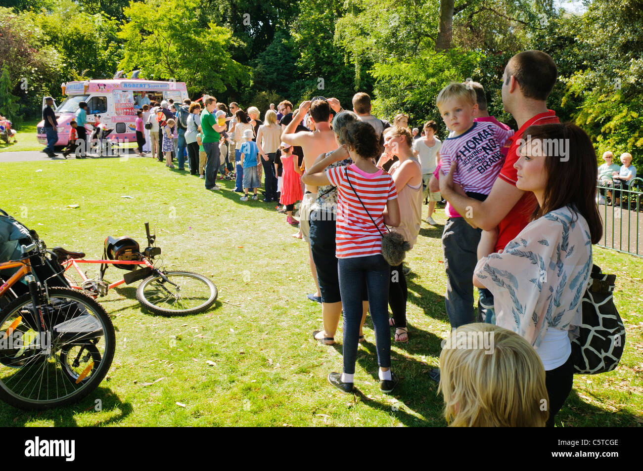 Very long queue in a park for an Ice Cream Van Stock Photo - Alamy