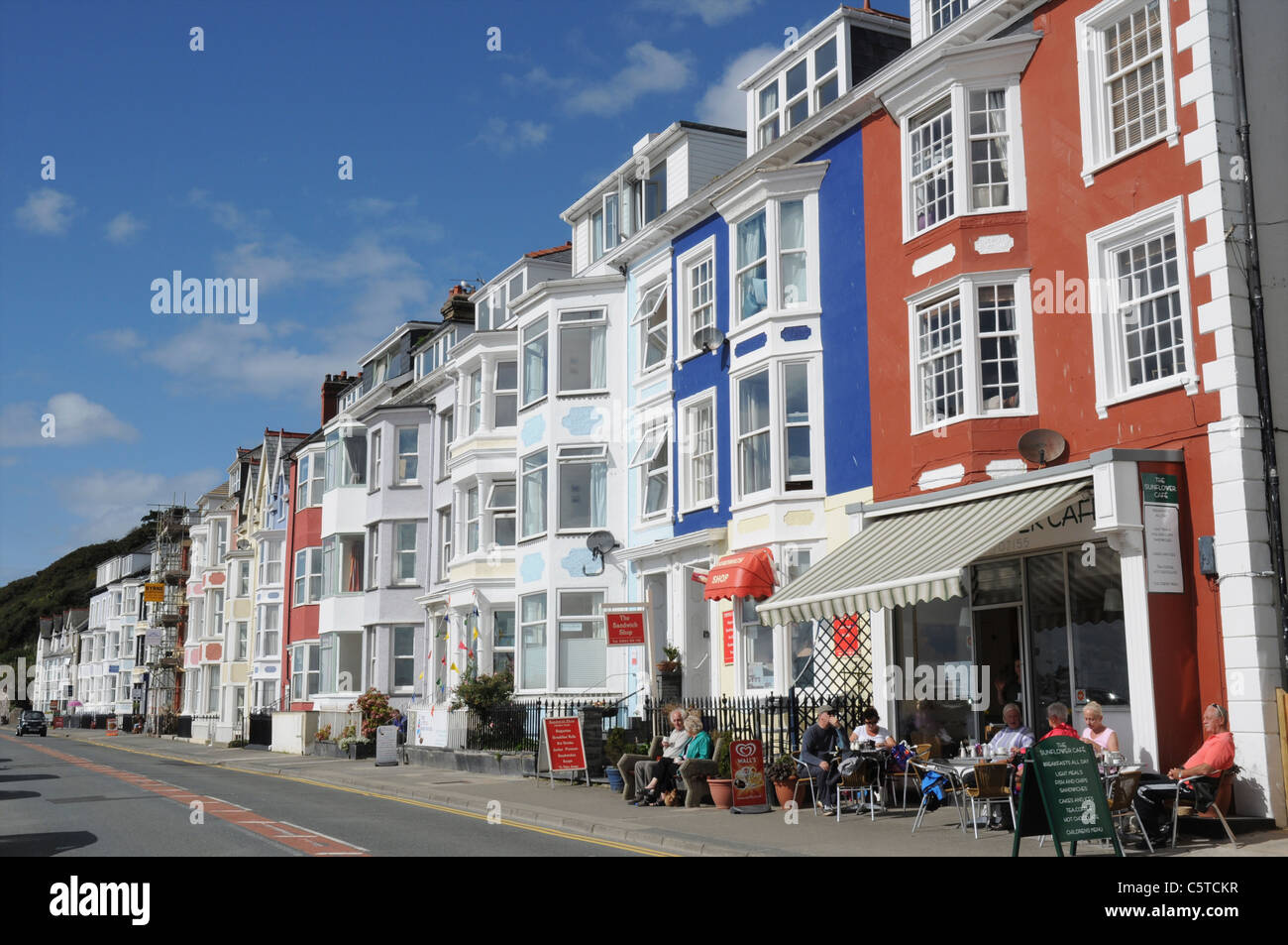 People at cafe with row of terraced shops and hotels, Aberdovey (or ...