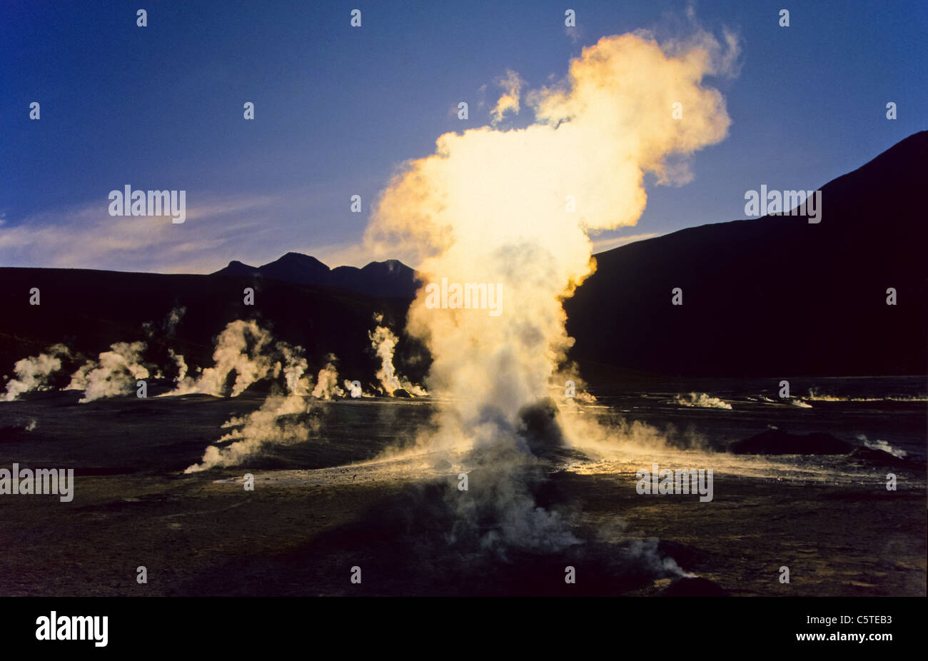 Geyser steam erupting in front of the sun in the Tatio basin in Chile ...