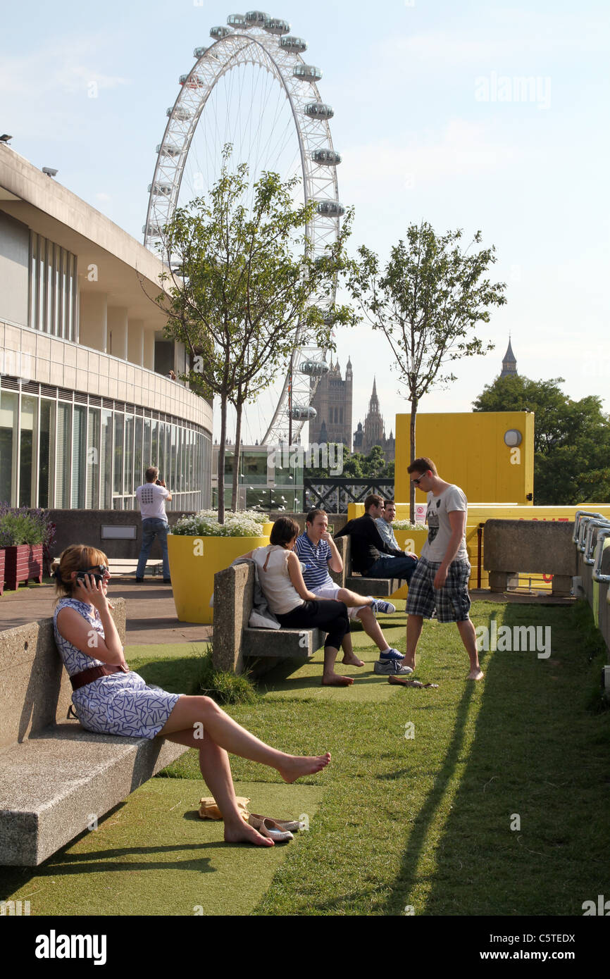 People talking and drinking at the South Bank centre in London with ...