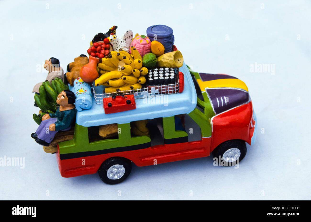 Wooden colorful painted toy buss full of people and luggage Stock Photo ...