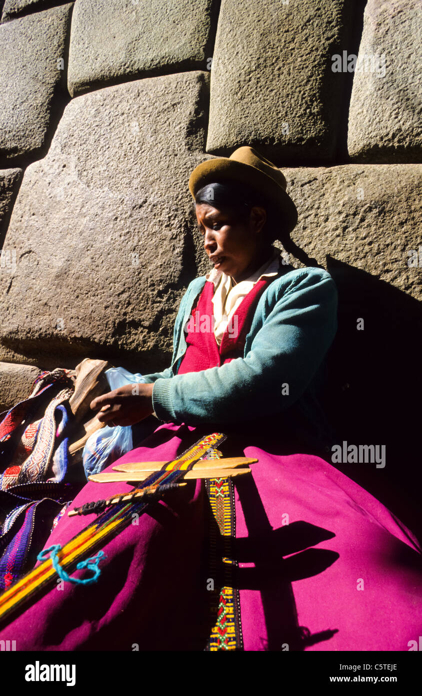 Indian woman weaving next to the stone foundation of an Inka temple in ...