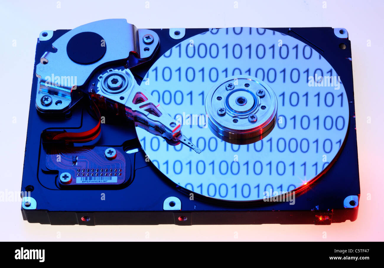 Computer hard drive, opened, writing/reading head and hard disk. Binary ...