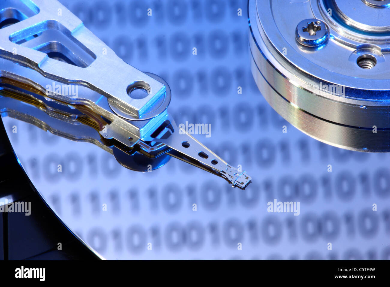 Computer hard drive, opened, writing/reading head and hard disk. Binary ...