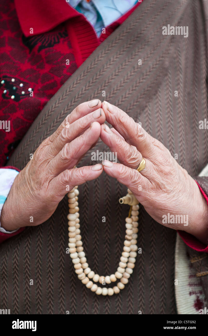Elderly pilgrim with prayer beads, Kumbum Monastery, Huangzhong ...