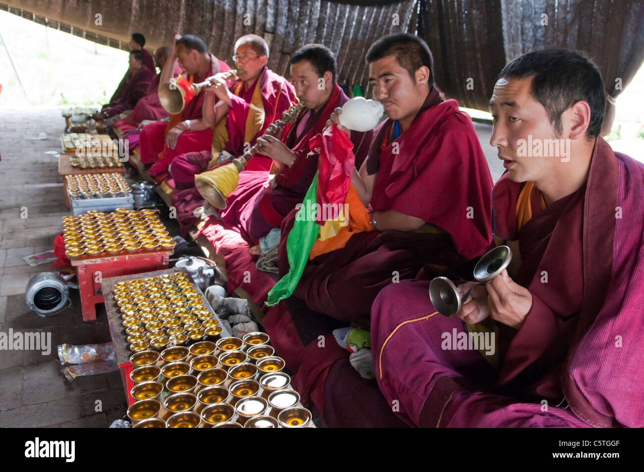 Tibetan Buddhist monks play instruments in summer time horse hair tent ...