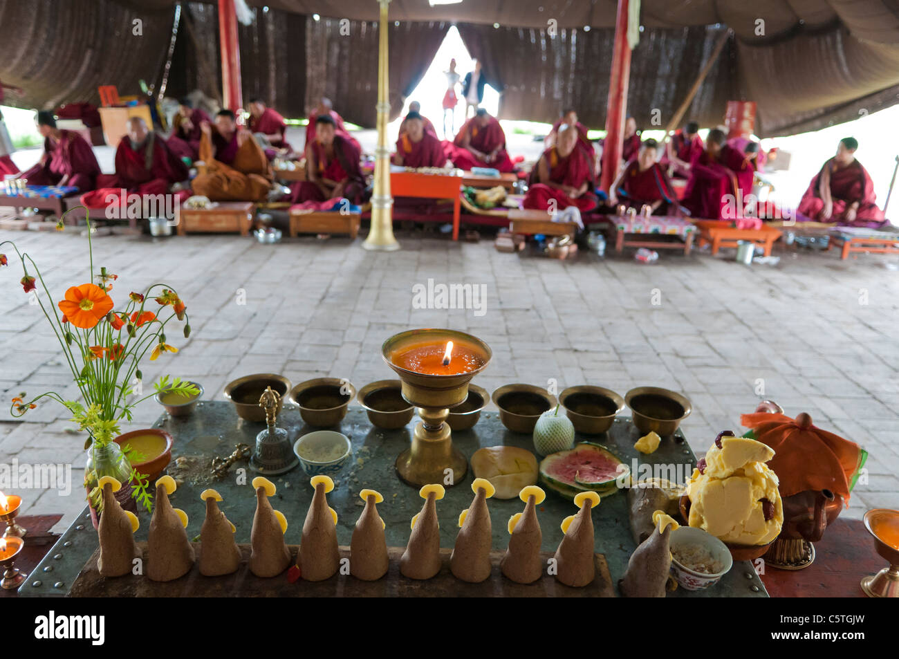 Tibetan Buddhist monks pray at altar of tsampa, Arou Ba Temple, Qilian ...