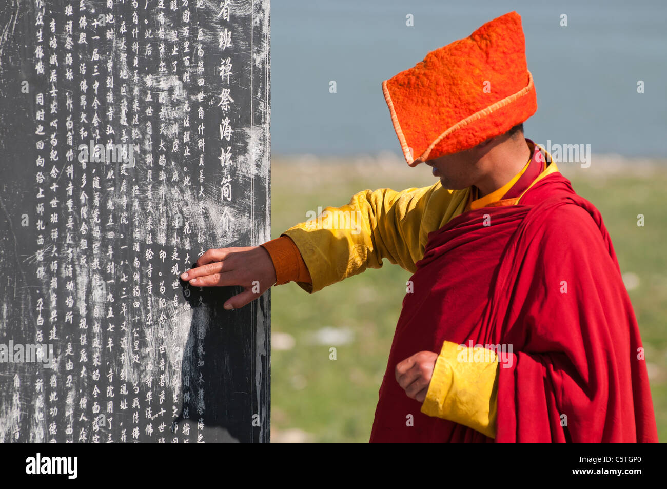 Buddhist Monk visits shrine along shores of Qinghai Lake, Qinghai ...