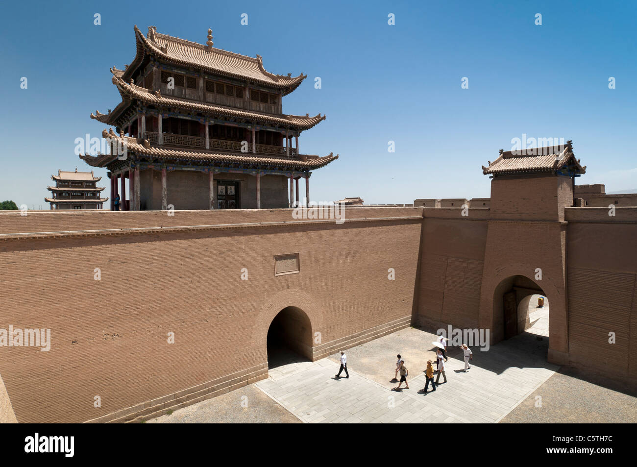 Rammed earth walls tower above courtyard at Jiayuguan Fort, part of ...