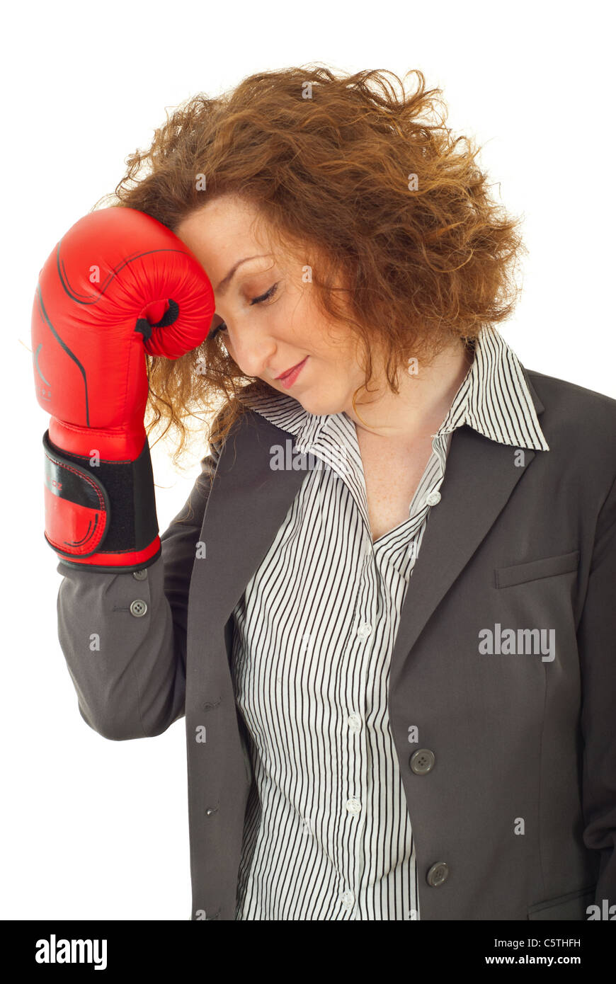 Profile of loser business woman holding hand in boxing glove to head ...