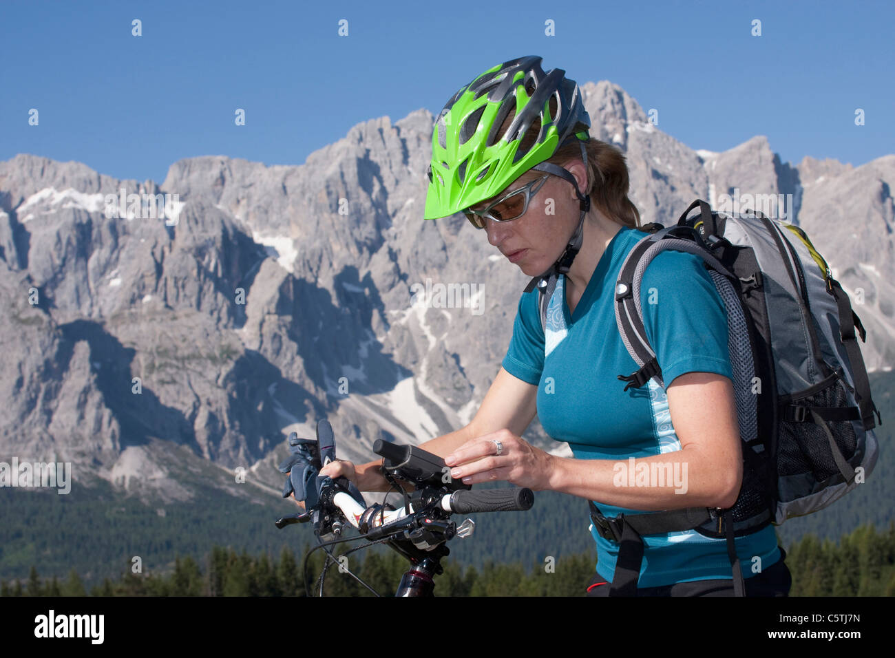 Italy, Dolomites, Female mountainbiker, side view, portrait, close-up ...