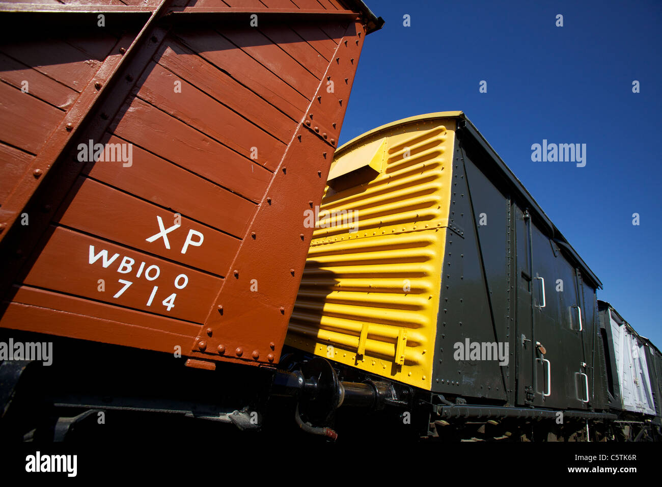 Yellow and terracotta steam train carriages at Levisham Railway Station ...