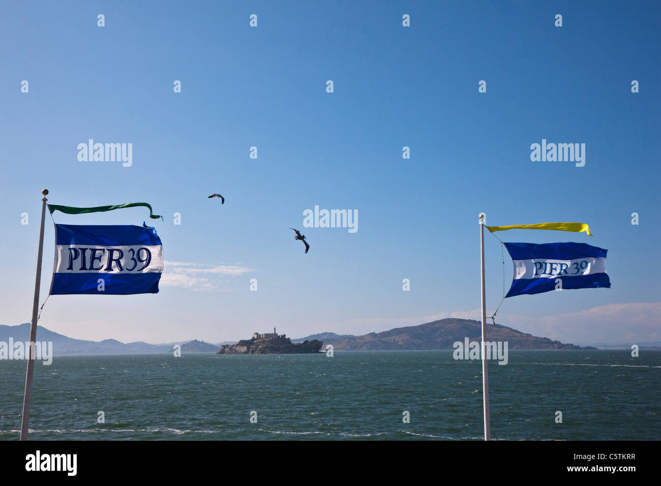 USA, California, San Francisco, Alcatraz island, flags in foreground ...