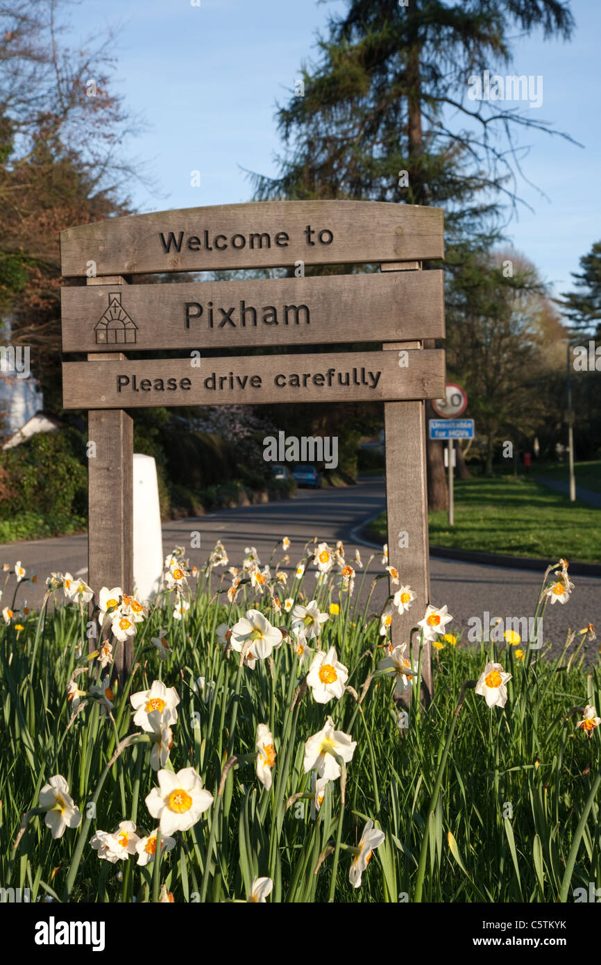 A wooden 'Welcome to Pixham - Please drive carefully' sign erected at ...